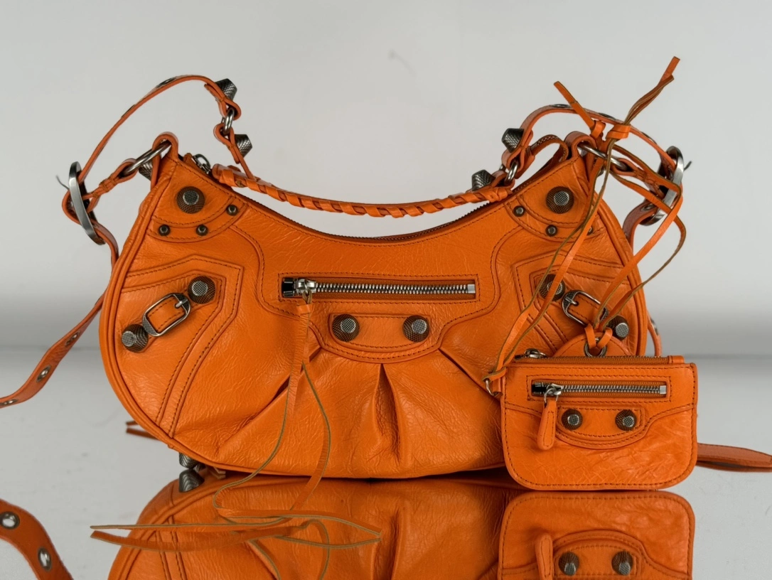 Balenciaga Le Cagole Half-Moon Dumpling Bag in Oil Wax Orange