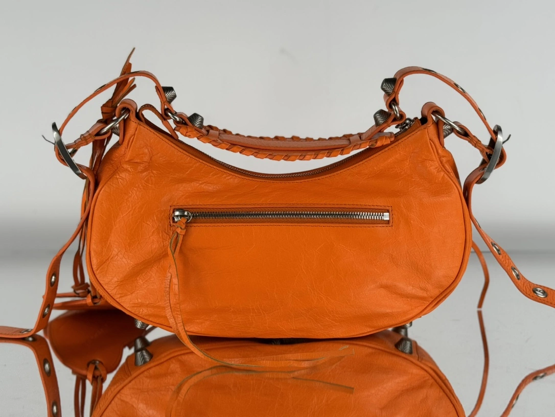 Value-priced Balenciaga Le Cagole Half-Moon Dumpling Bag in Oil Wax Orange