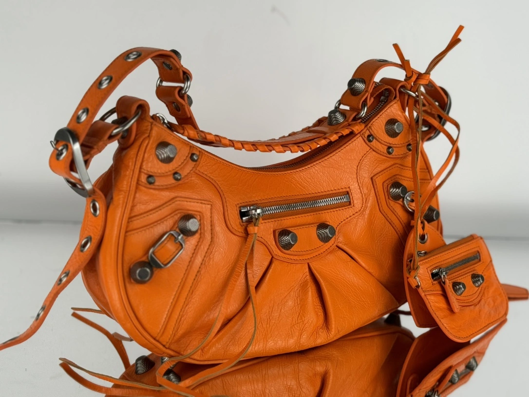 Value-priced Balenciaga Le Cagole Half-Moon Dumpling Bag in Oil Wax Orange