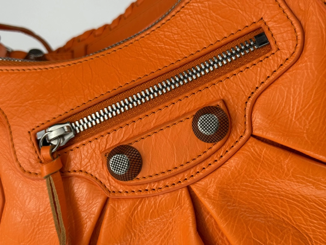 Value-priced Balenciaga Le Cagole Half-Moon Dumpling Bag in Oil Wax Orange