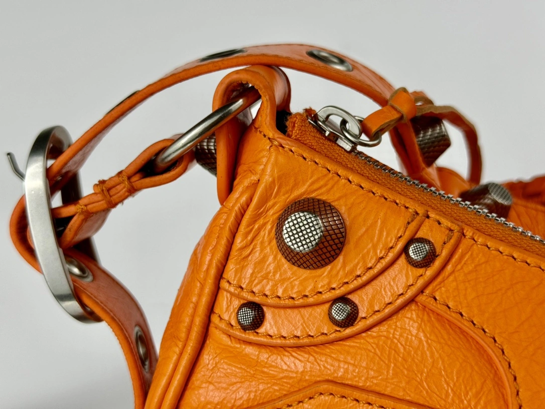 Value-priced Balenciaga Le Cagole Half-Moon Dumpling Bag in Oil Wax Orange