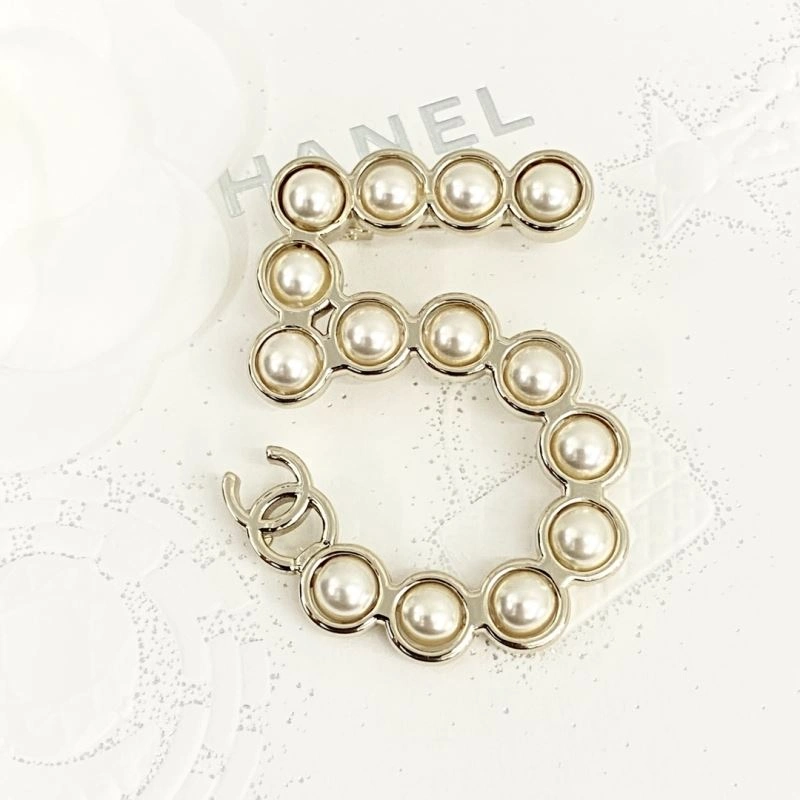 Indistinguishable Chanel Brooches